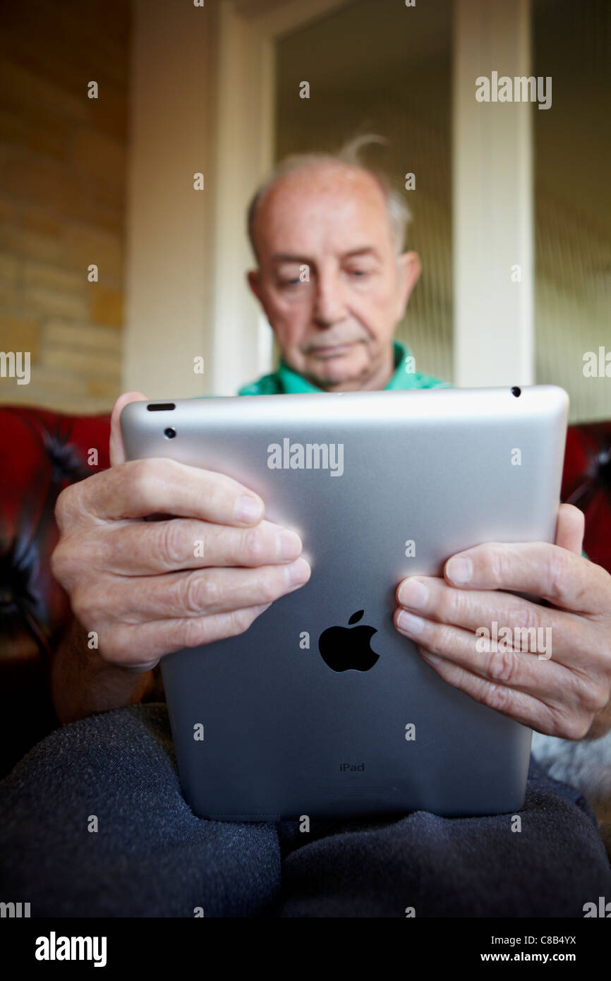 a pensioner uses a ipad at home Stock Photo - Alamy