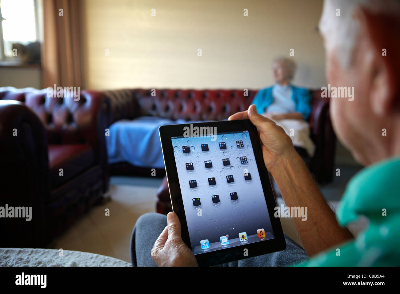 a pensioner uses a ipad at home Stock Photo - Alamy