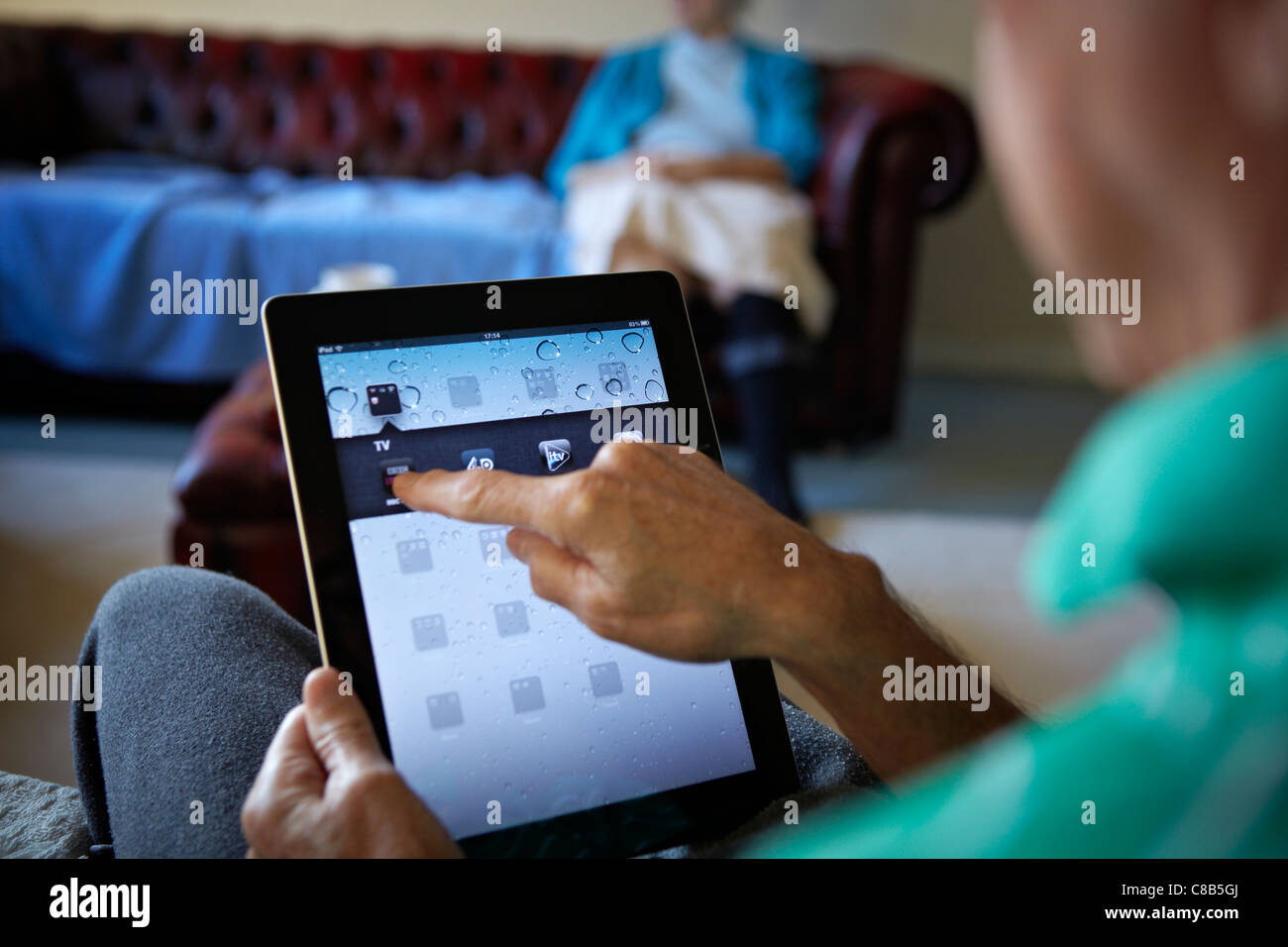 a pensioner uses a ipad at home Stock Photo - Alamy