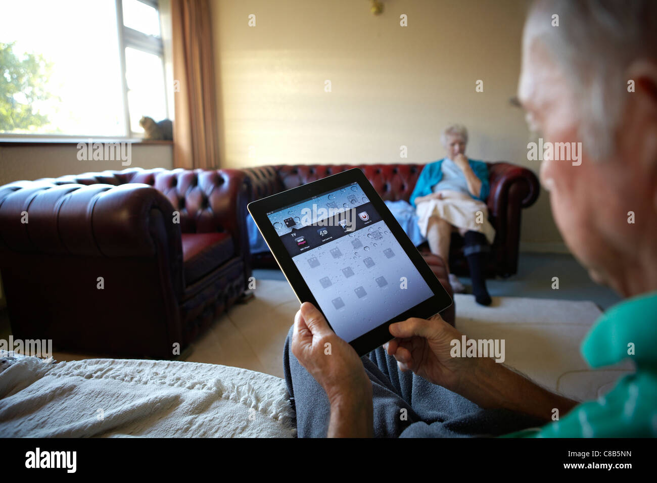 a pensioner uses a ipad at home Stock Photo - Alamy