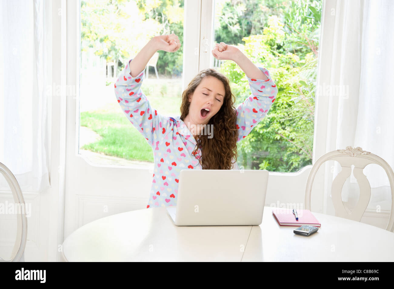Young woman yawning Stock Photo - Alamy