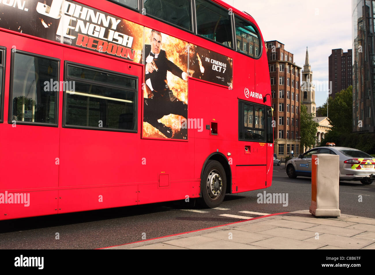 A double decker red London bus waiting to enter a roundabout Stock ...
