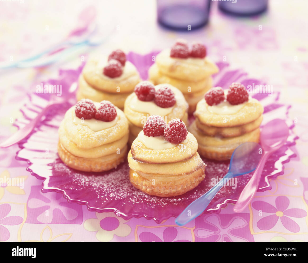 Flaky pastry tarts with cream and raspberries Stock Photo - Alamy