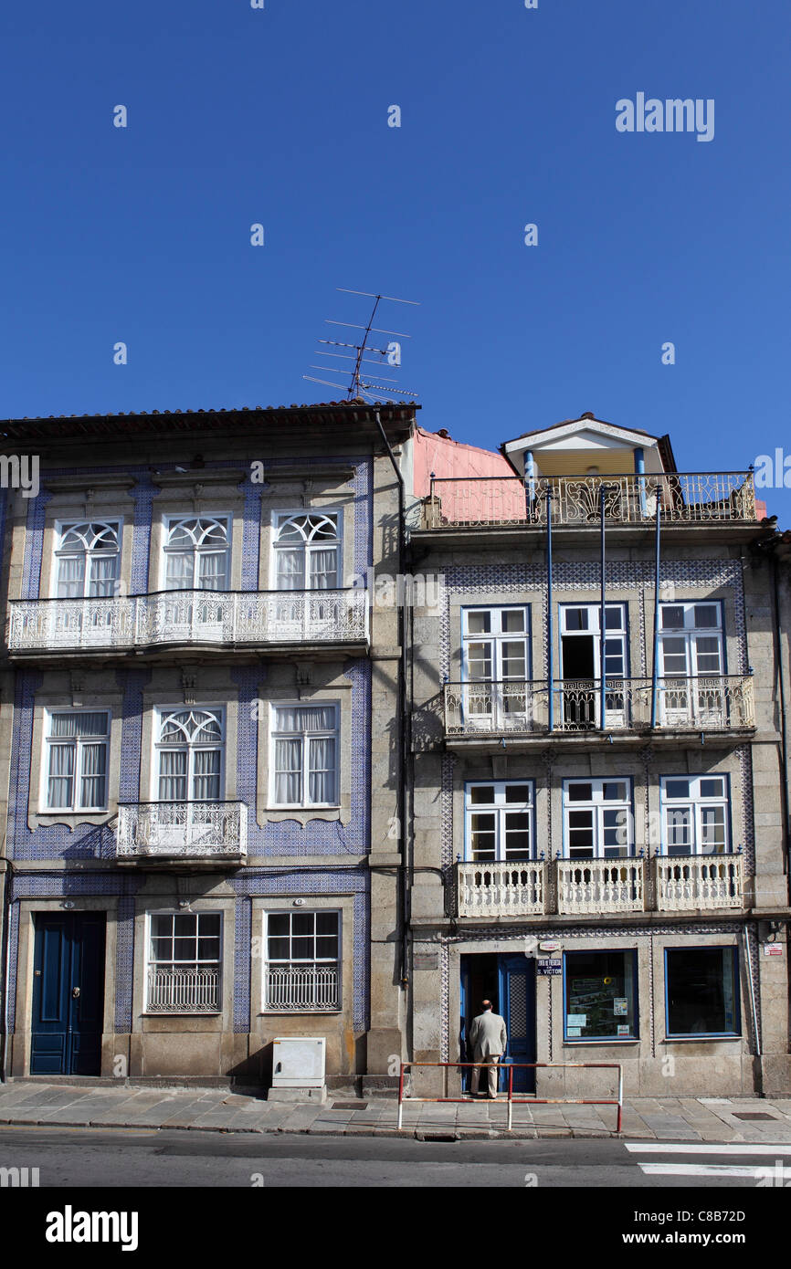 A man enters a traditional Portuguese building in Braga, Portugal Stock ...