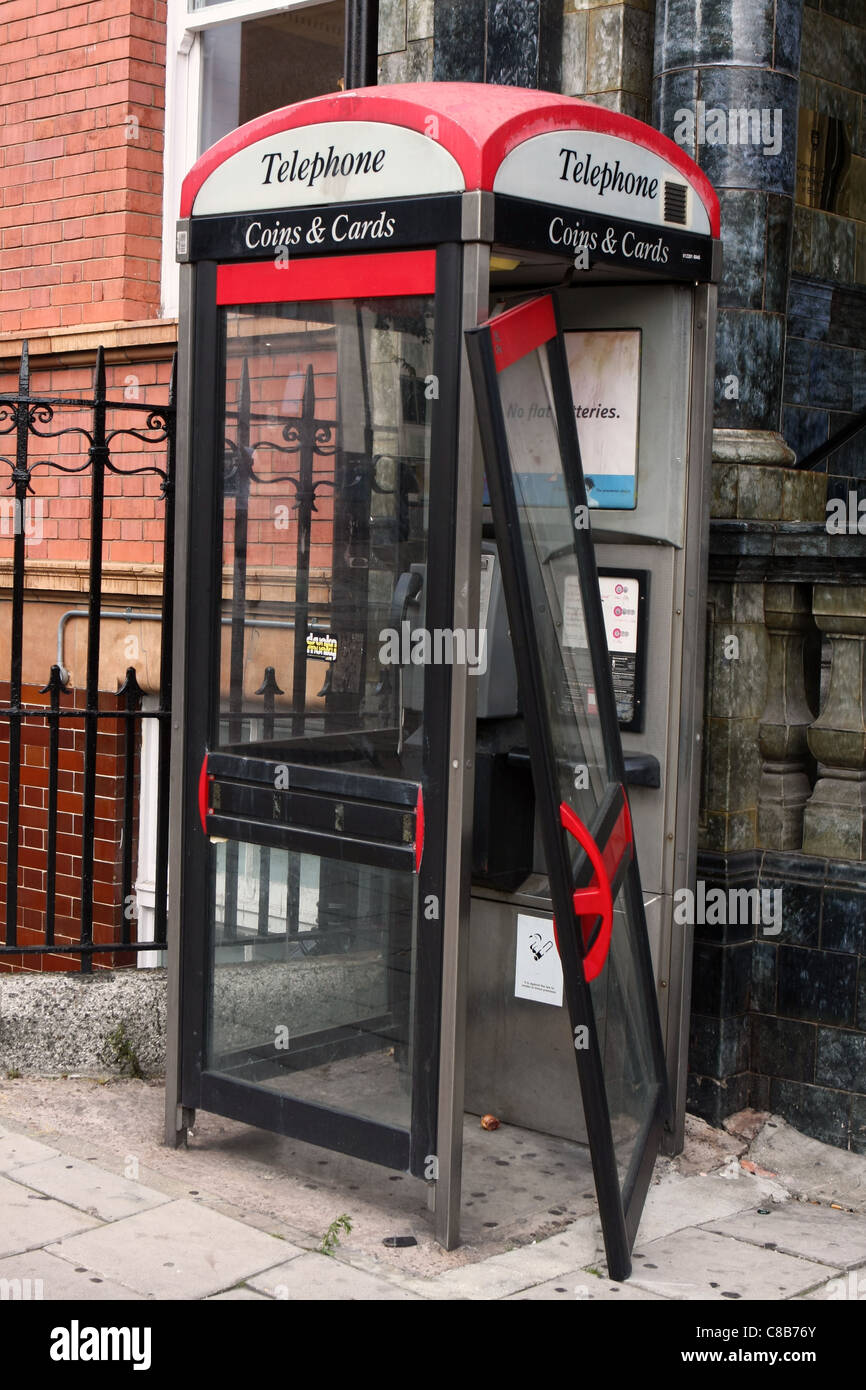 a London public telephone box with a broken door Stock Photo - Alamy