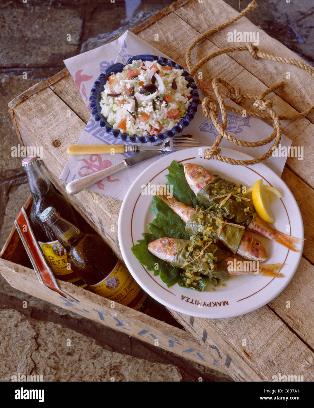 grilled fillets of mullet wrapped in vine leaves with rice Stock Photo ...