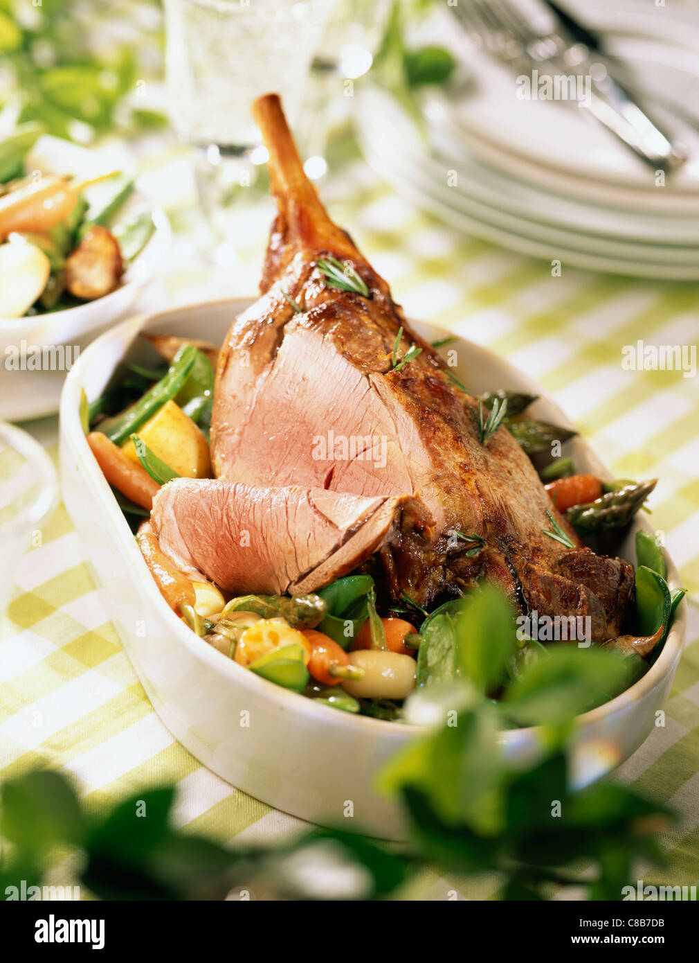 Leg of lamb with spring vegetables Stock Photo - Alamy