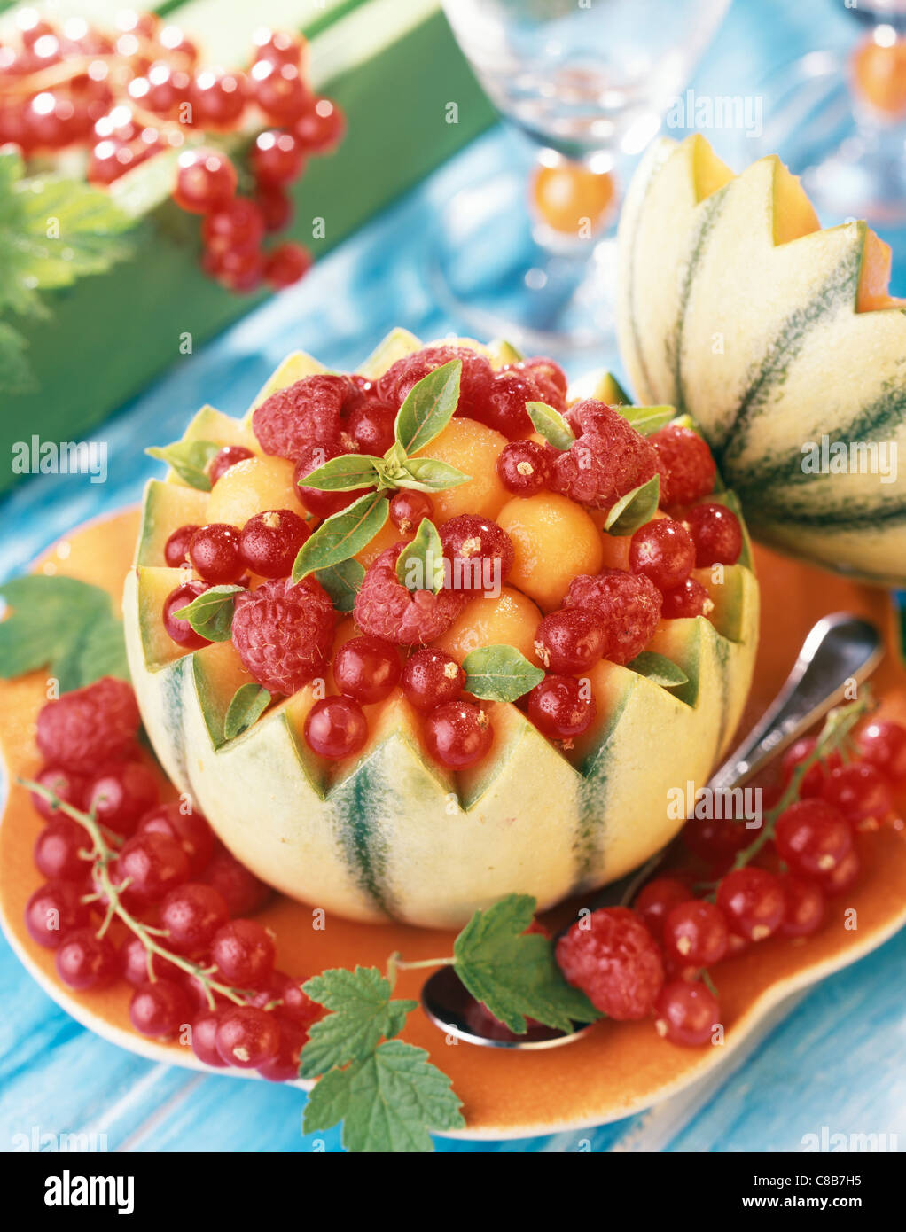 Melon filled with summer fruit Stock Photo - Alamy