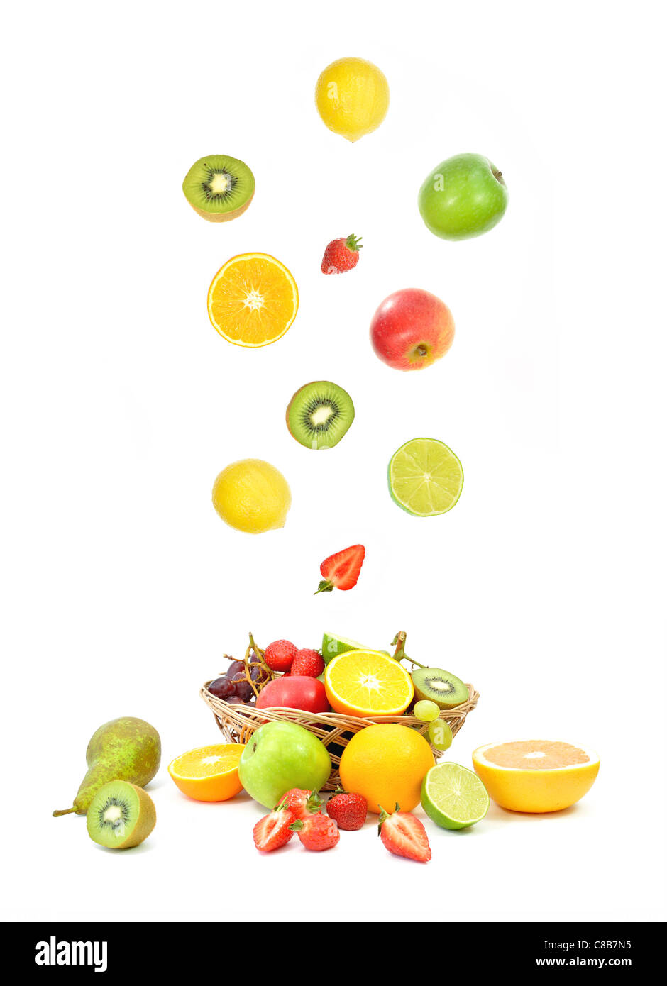 Array fruits falling into a basket Stock Photo - Alamy