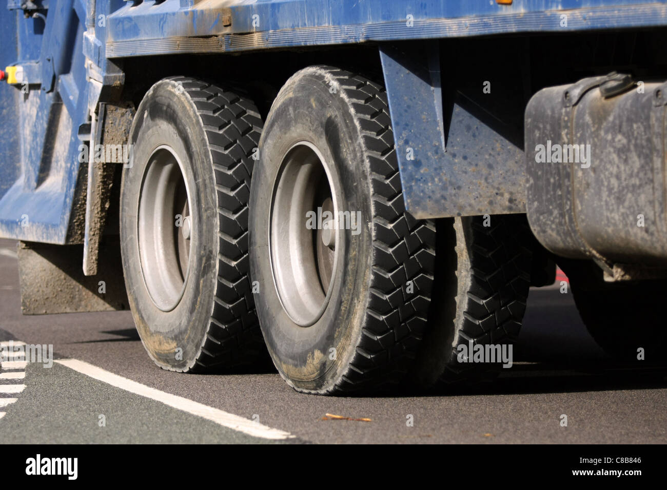 a low level view of the front wheels of a truck as it travels along a ...
