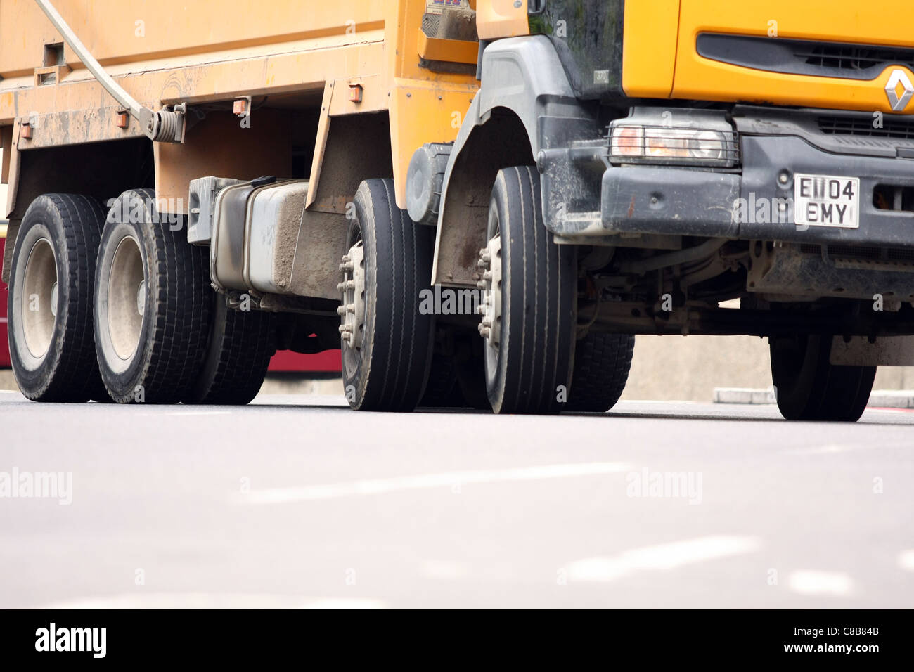 a low level view of the wheels of a truck as it travels along a road ...