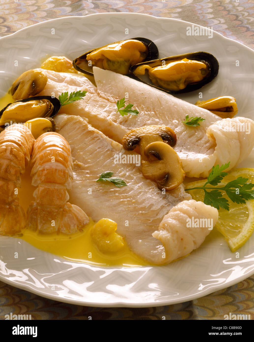 Normandy-style fillets of fish with seafood Stock Photo - Alamy