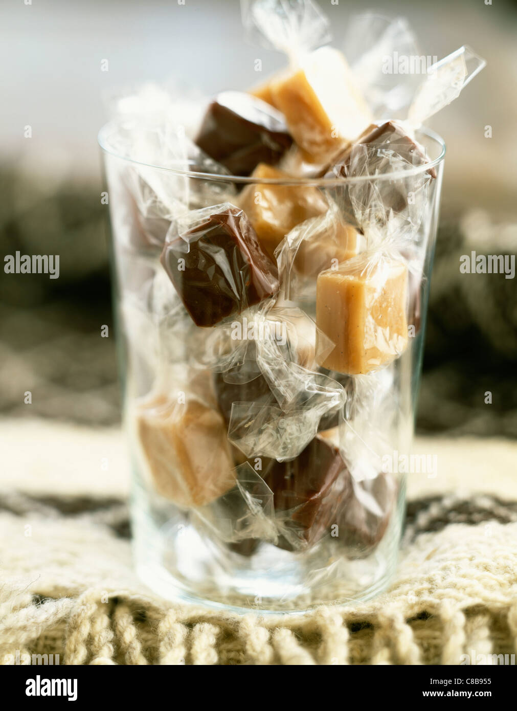 Wrapped toffees in glass Stock Photo - Alamy
