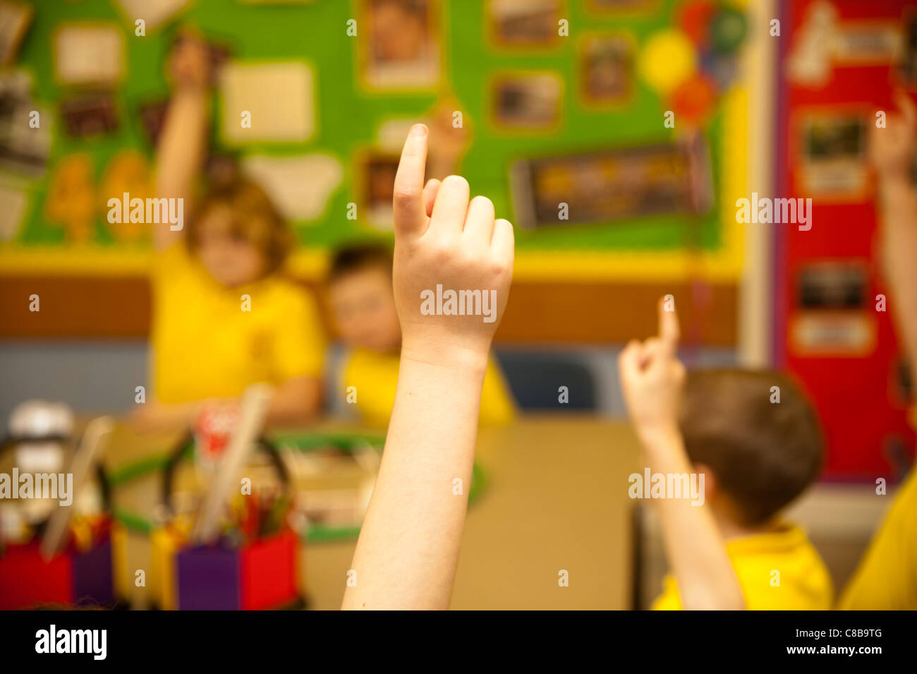 Uk school children hands up hi-res stock photography and images - Alamy