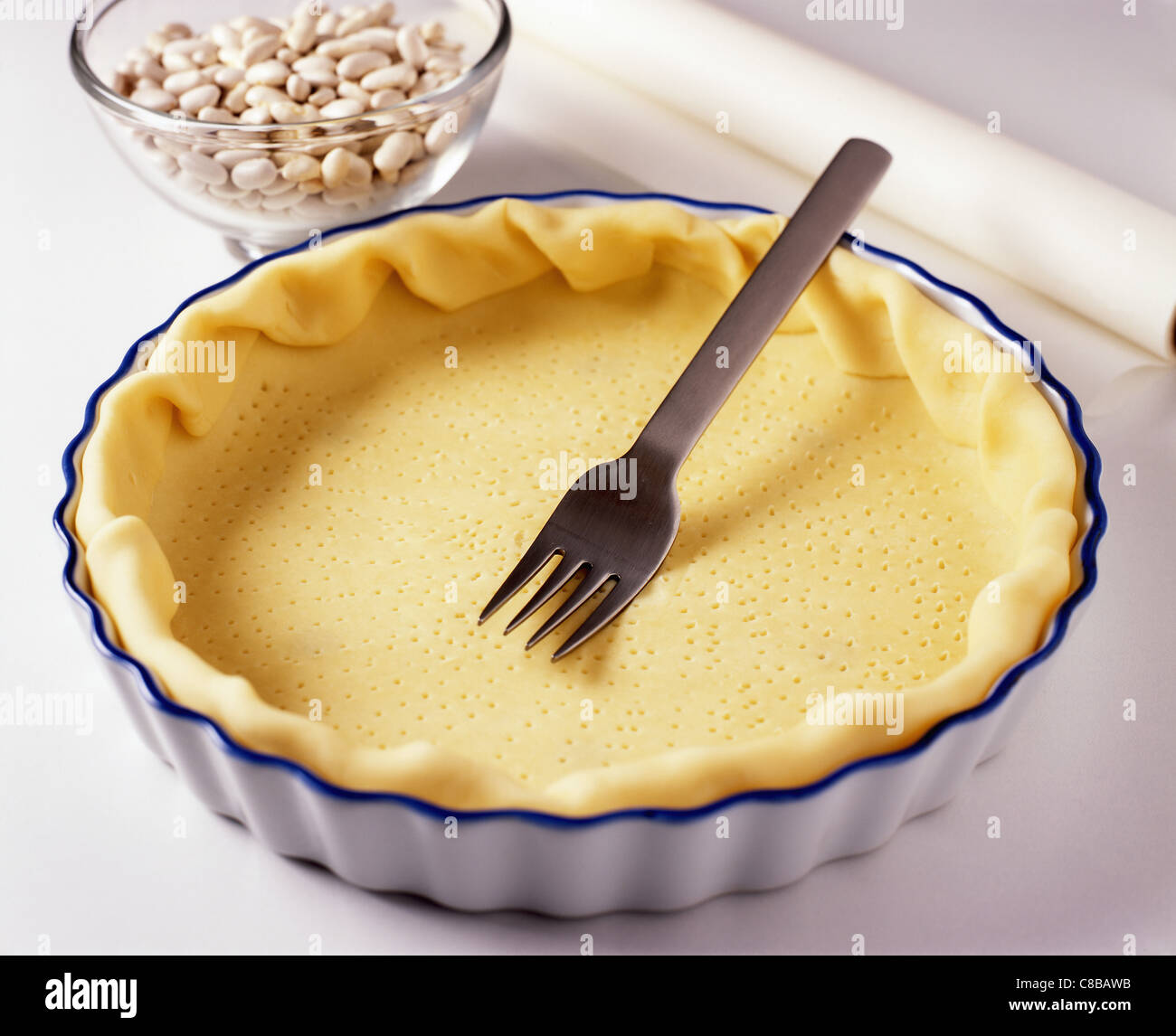 lining pastry tin and pricking pastry Stock Photo - Alamy