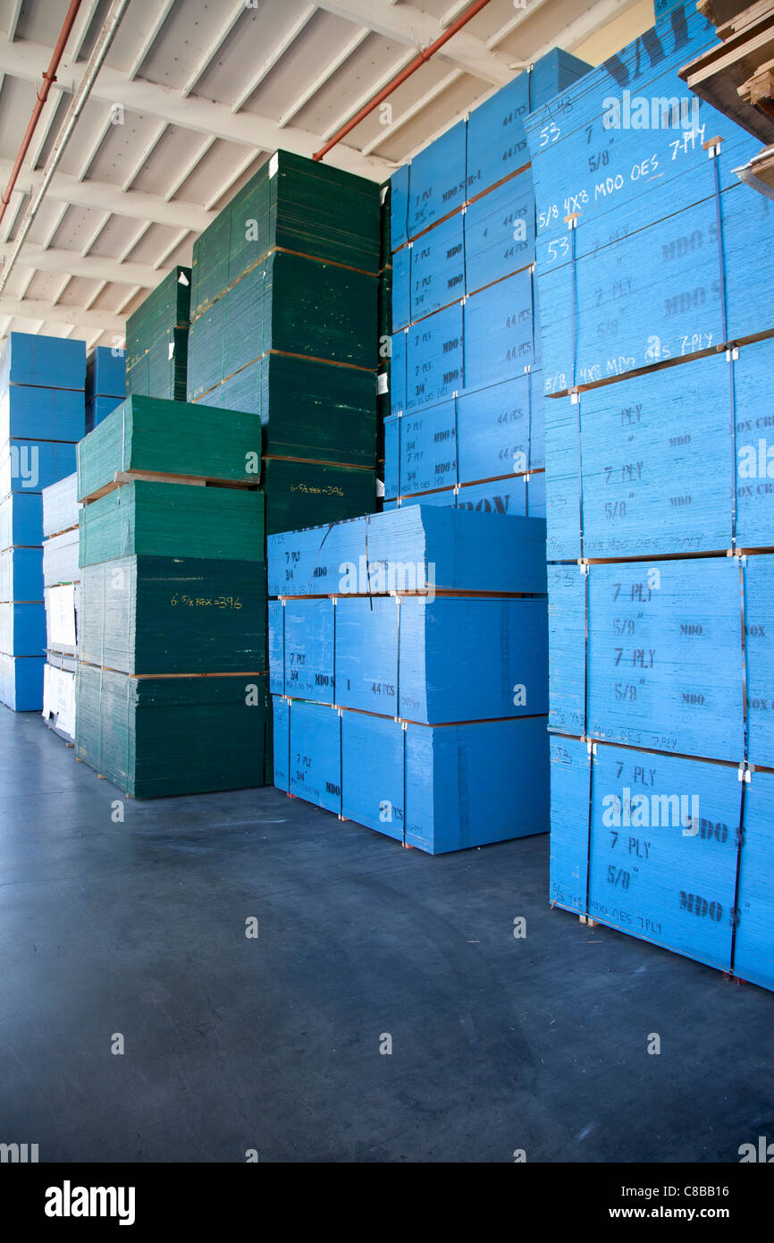 Blue boxes piled up of in warehouse Stock Photo - Alamy