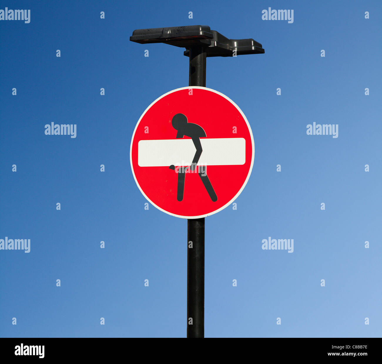 A no entry road sign which has been artistically modified with a person ...