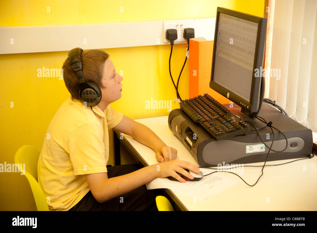 Primary school children in a classroom, Wales UK - a boy composing ...