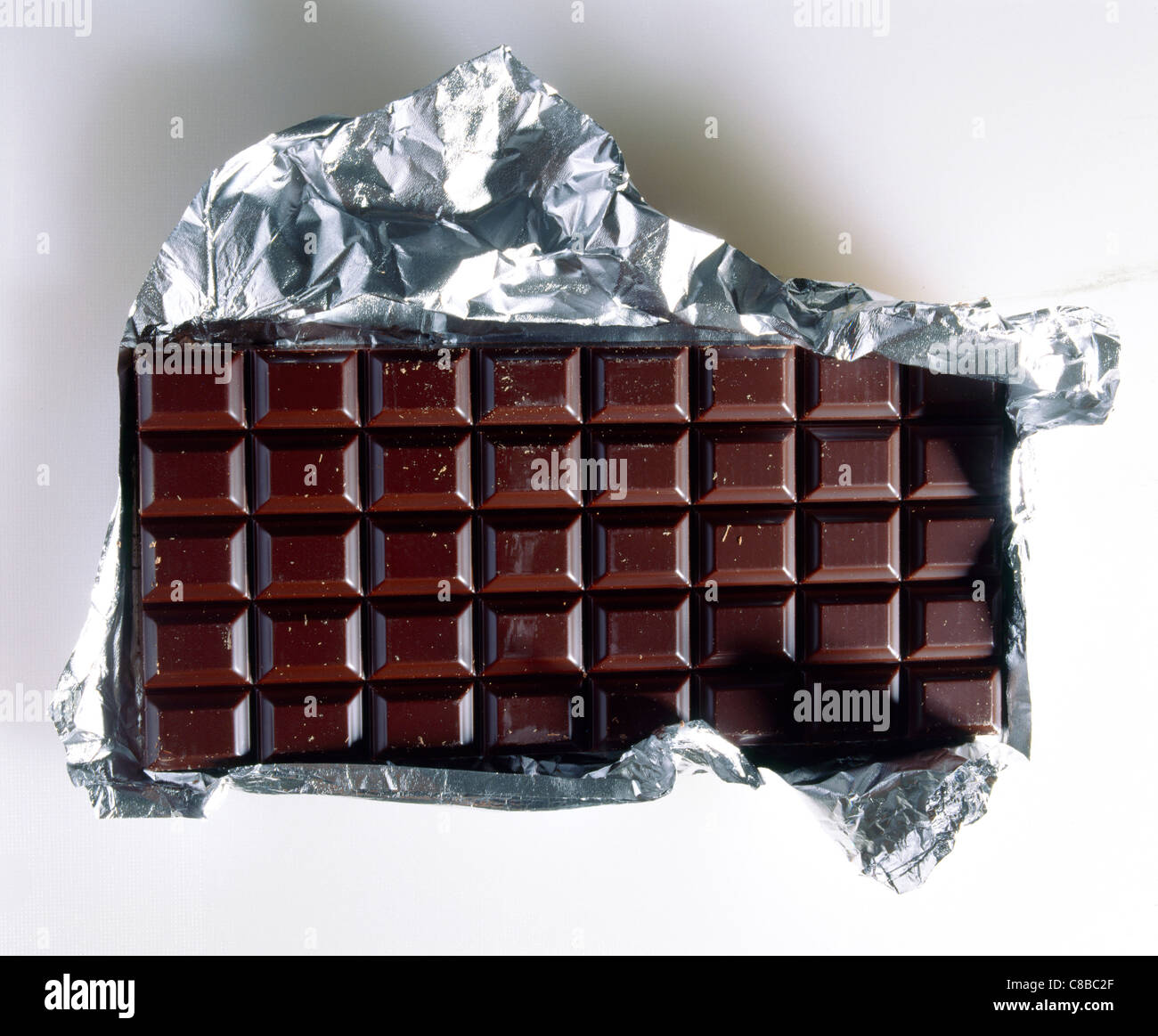 Bar of plain chocolate with foil wrapping Stock Photo - Alamy