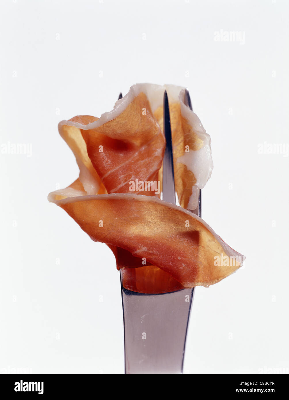 slice of raw ham on fork Stock Photo - Alamy