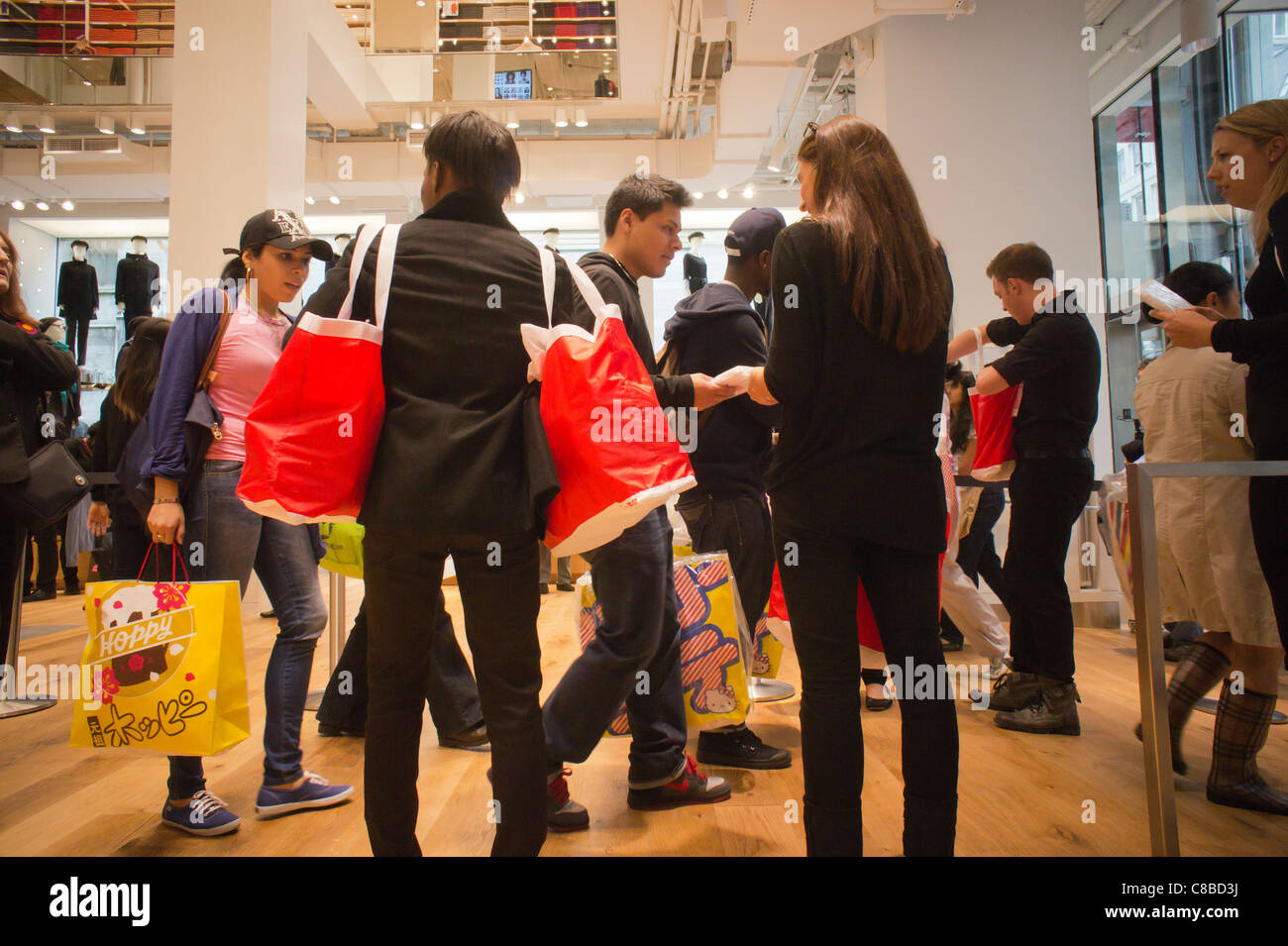 Customers shop at the grand opening of the Uniqlo Flagship store on ...
