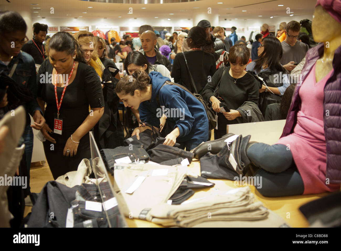 Customers shop at the grand opening of the Uniqlo Flagship store on ...