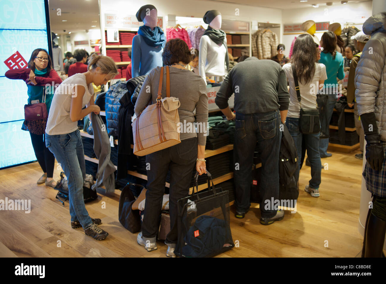 Customers shop at the grand opening of the Uniqlo Flagship store on ...