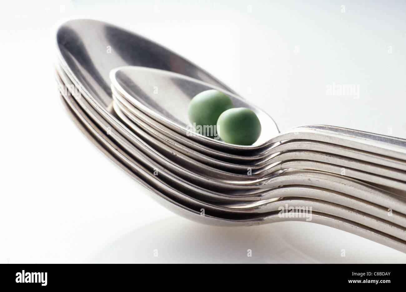 silver spoons and peas Stock Photo - Alamy