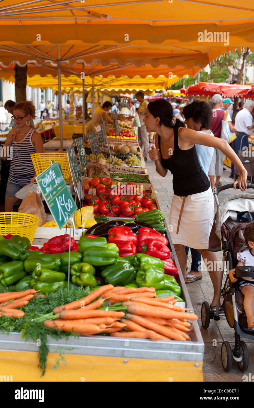 lady customer shopping for value, buying vegetables at the outdoor ...