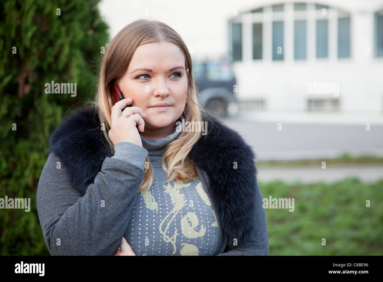 Young Russian beautiful girl calling by mobile phone outdoors. Summer ...