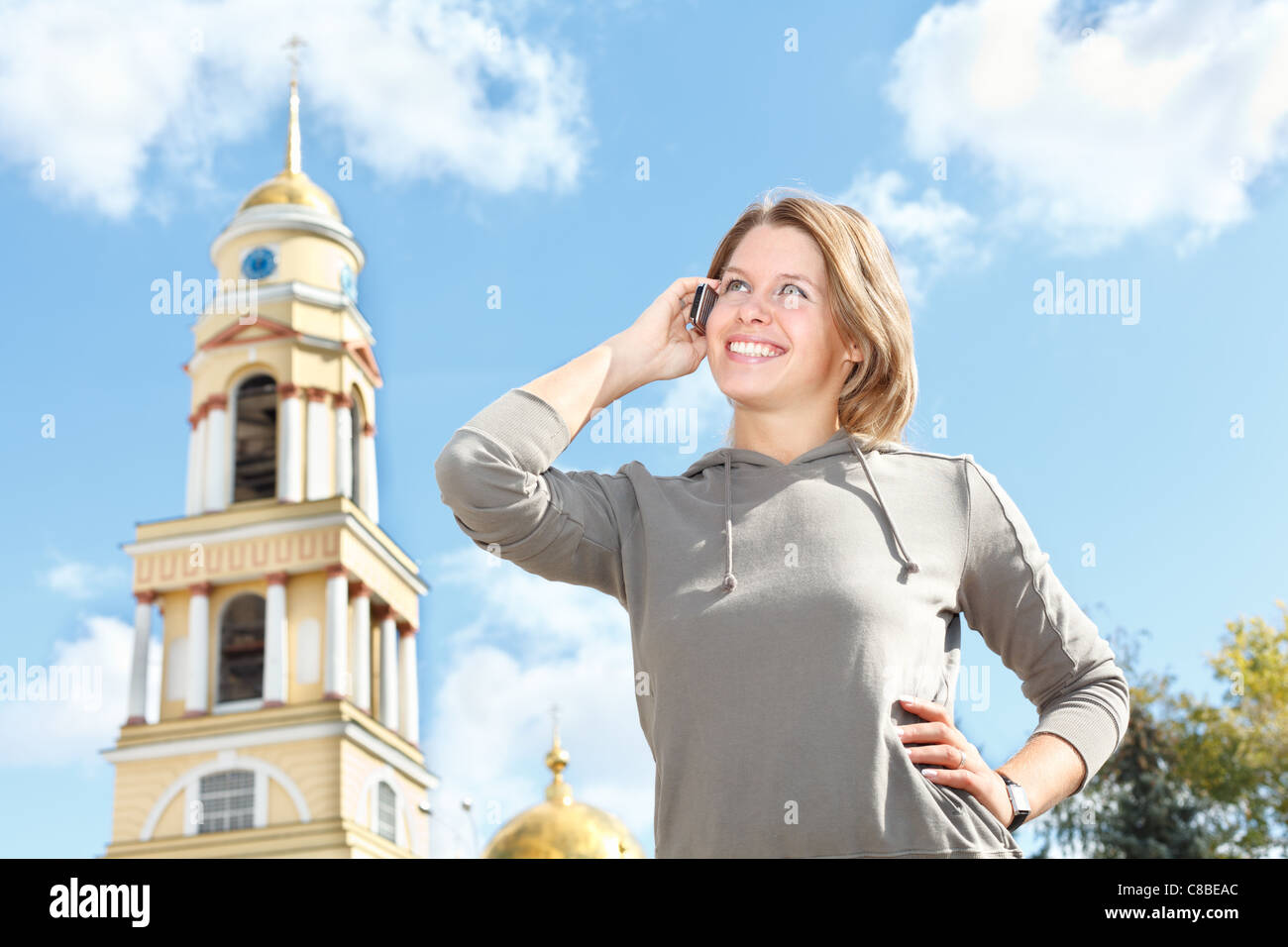 Young Russian beautiful girl calling by mobile phone outdoors. Summer ...