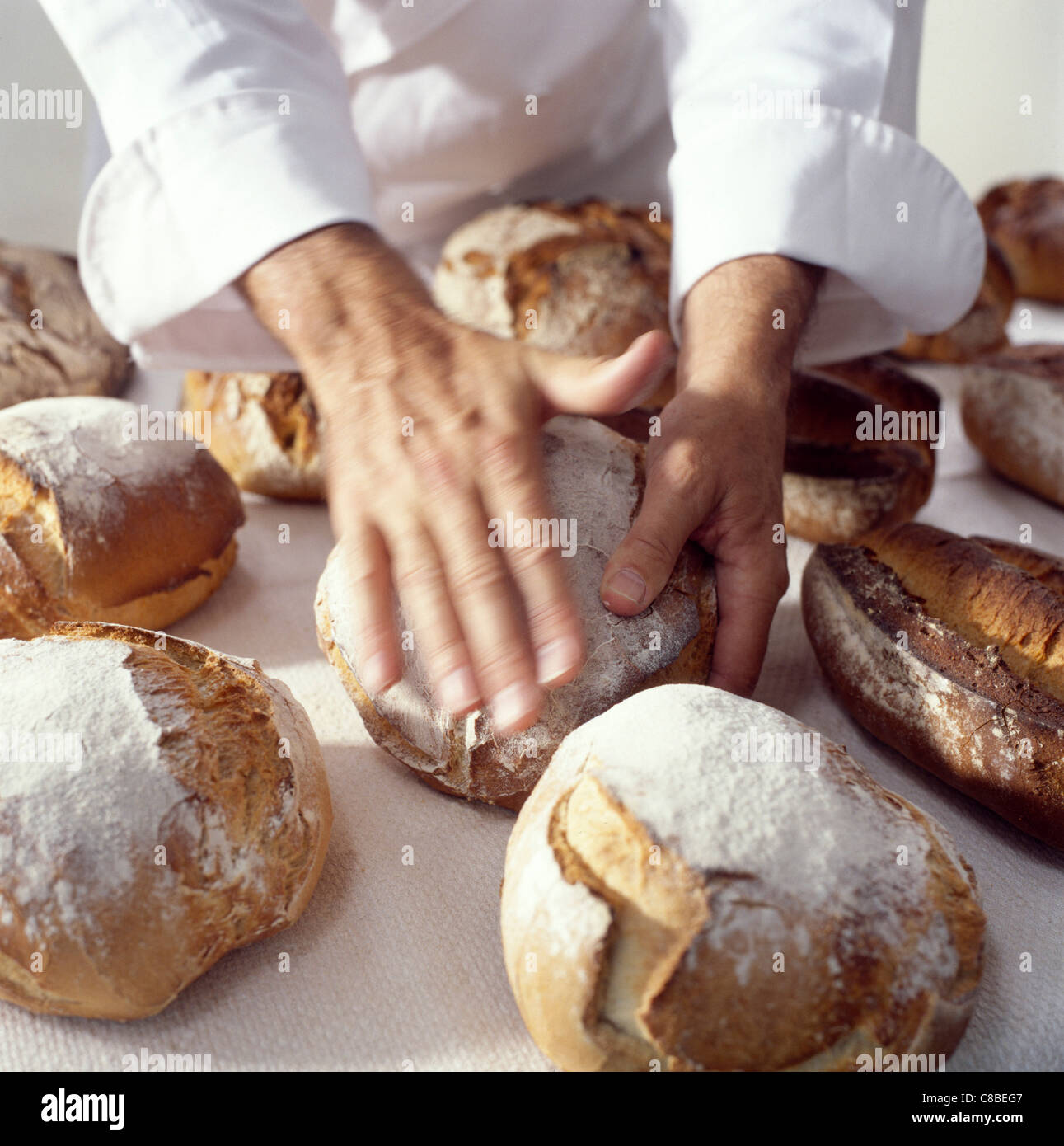 Baker with loaves of bread Stock Photo - Alamy