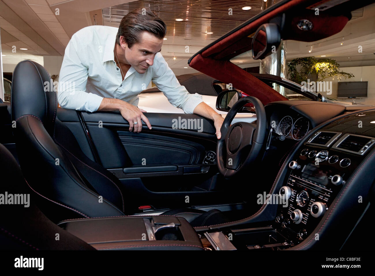 Man checking out his new car Stock Photo - Alamy