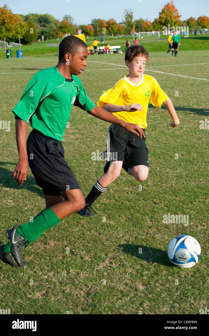 Boys 11 12 13 playing soccer football futball in a youth sports league ...