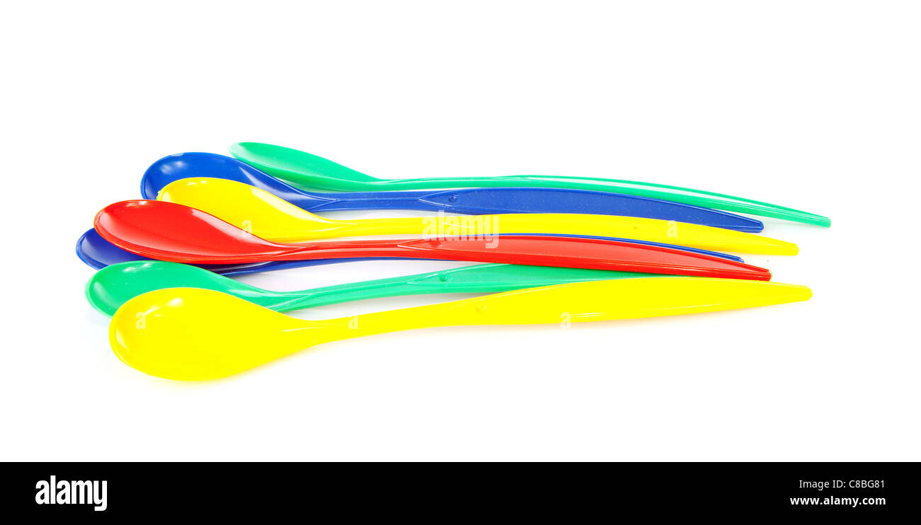 pile of colorful plastic spoons over white background Stock Photo - Alamy
