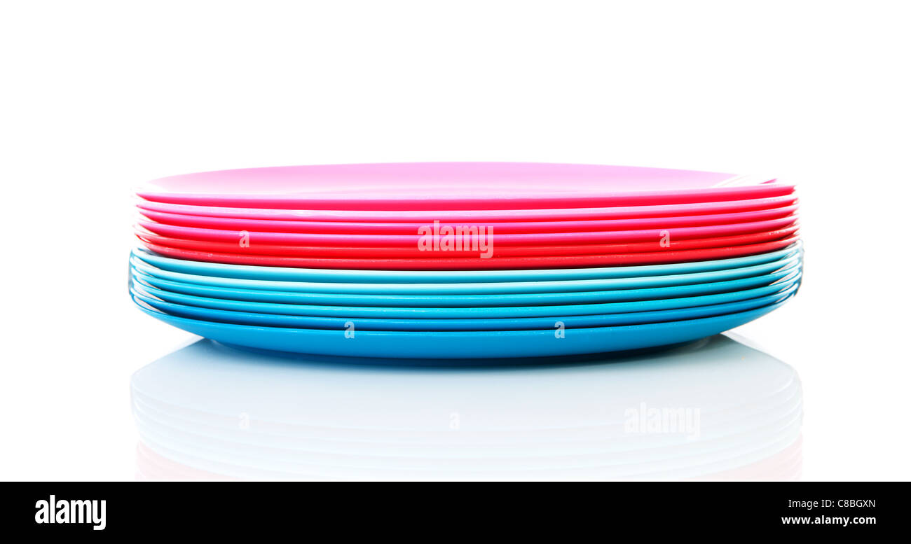 Pile of colorful plastic plates over white background Stock Photo - Alamy