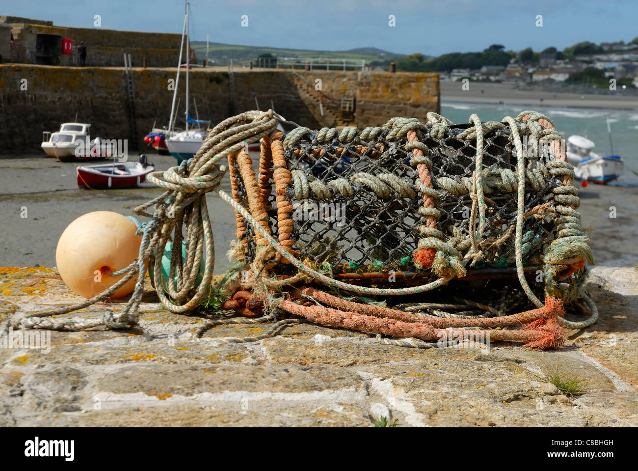Lobster pot sat on a harbour wall in Cornwall, Uk Stock Photo - Alamy