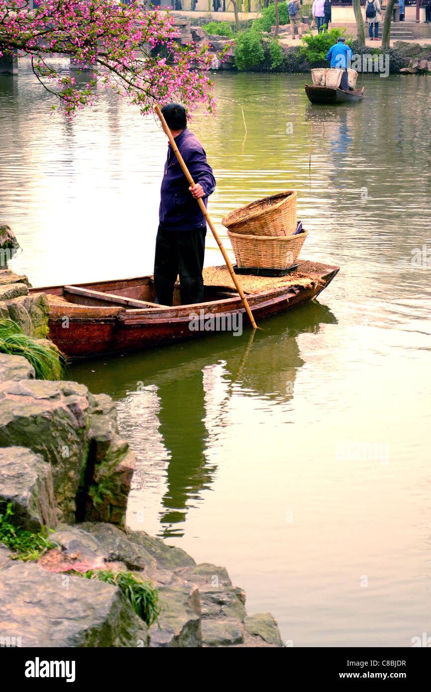 Chinese man on traditional boat Stock Photo - Alamy