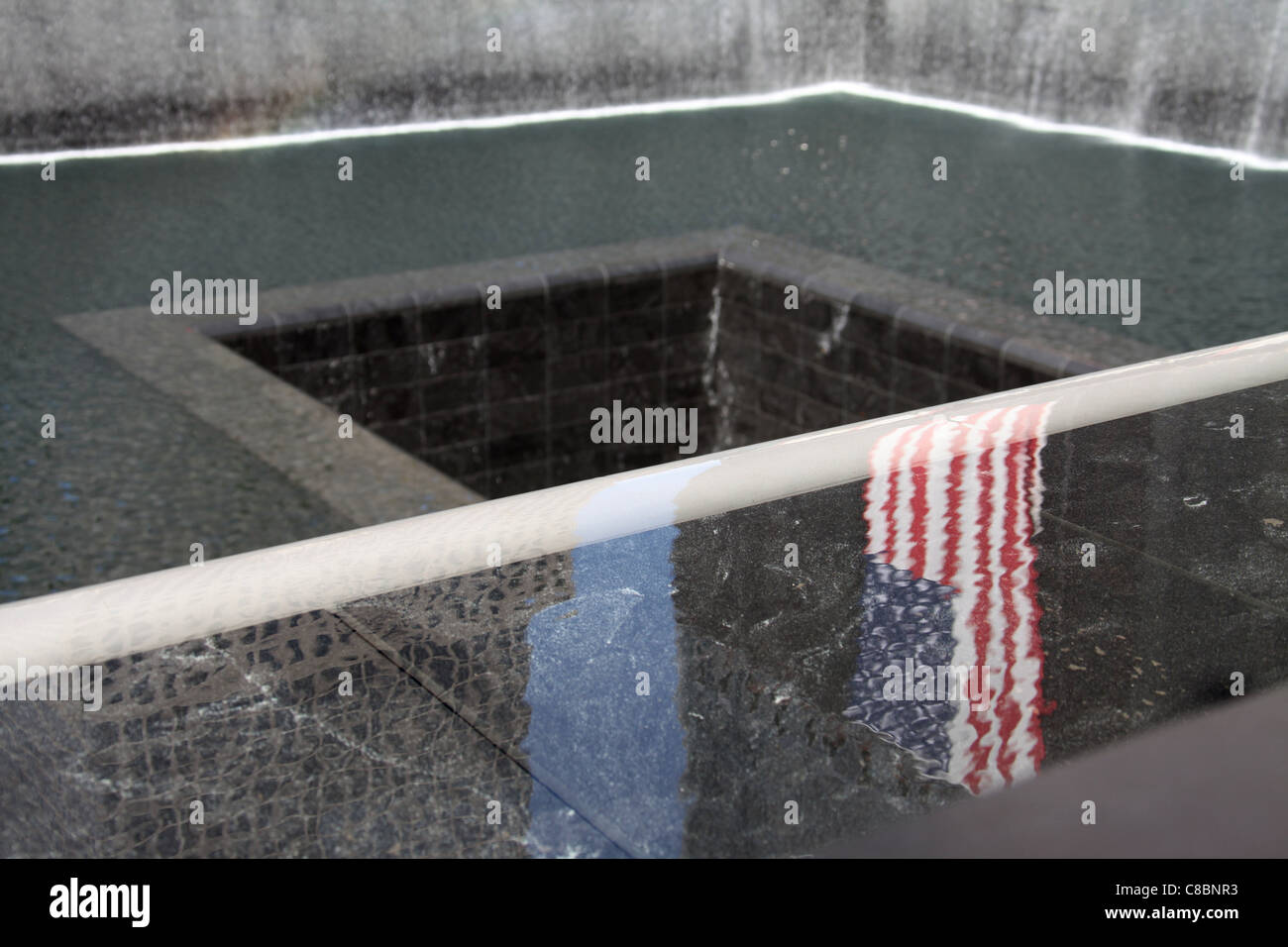 American Flag reflecting in a pool at the National September 11 ...