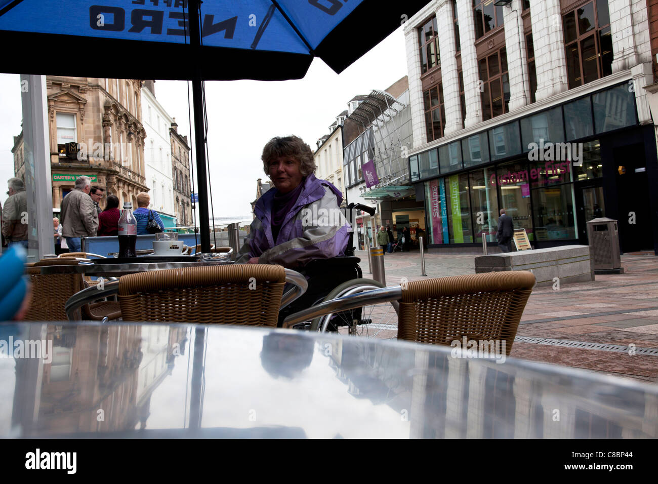 Stirling, Scotland, old disabled lady in wheelchair enjoying a coffee ...