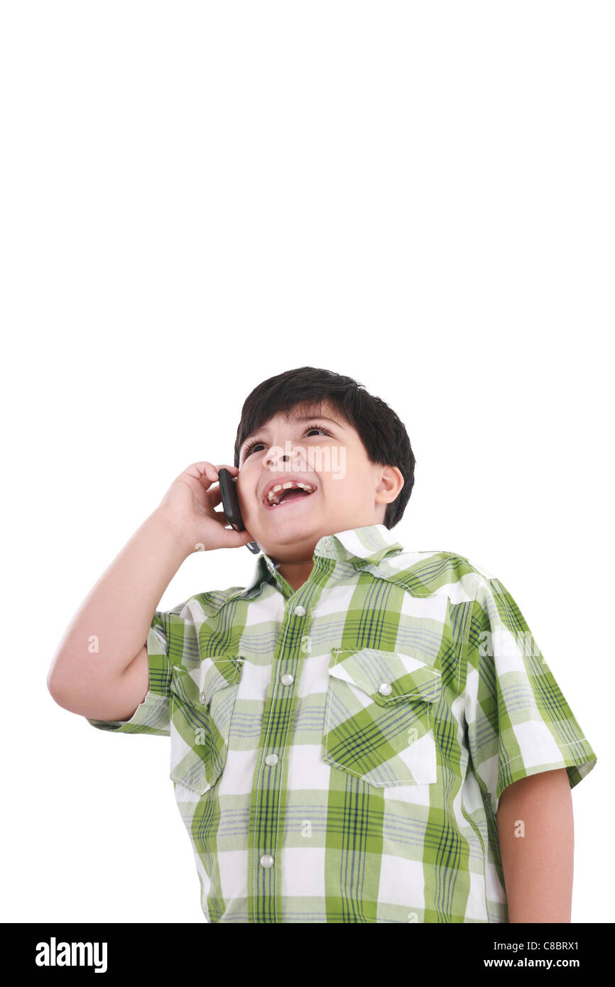 Beautiful little boy laughs and talks by mobile phone Stock Photo - Alamy