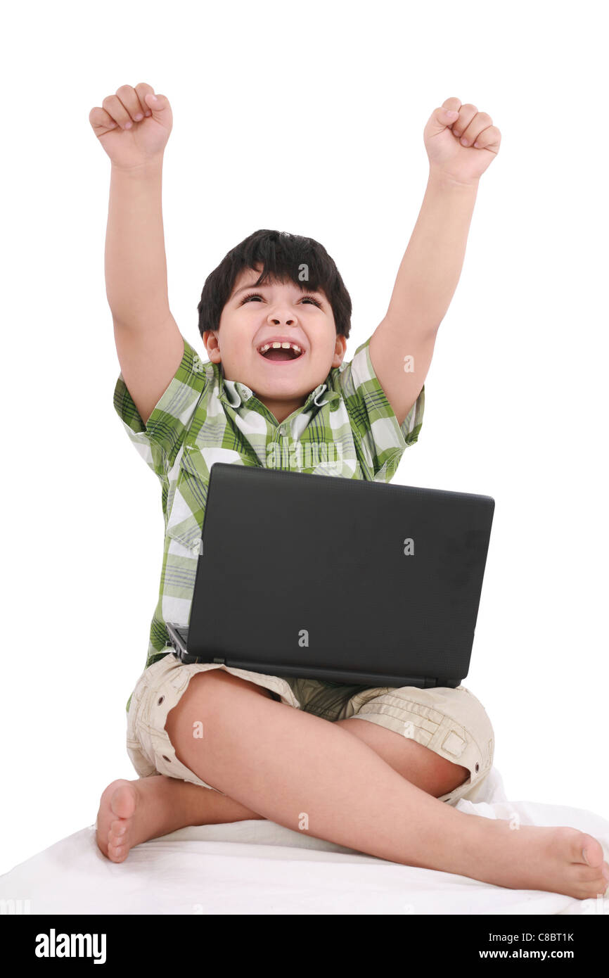Happy little boy with laptop with moving apart his hands - indoors ...