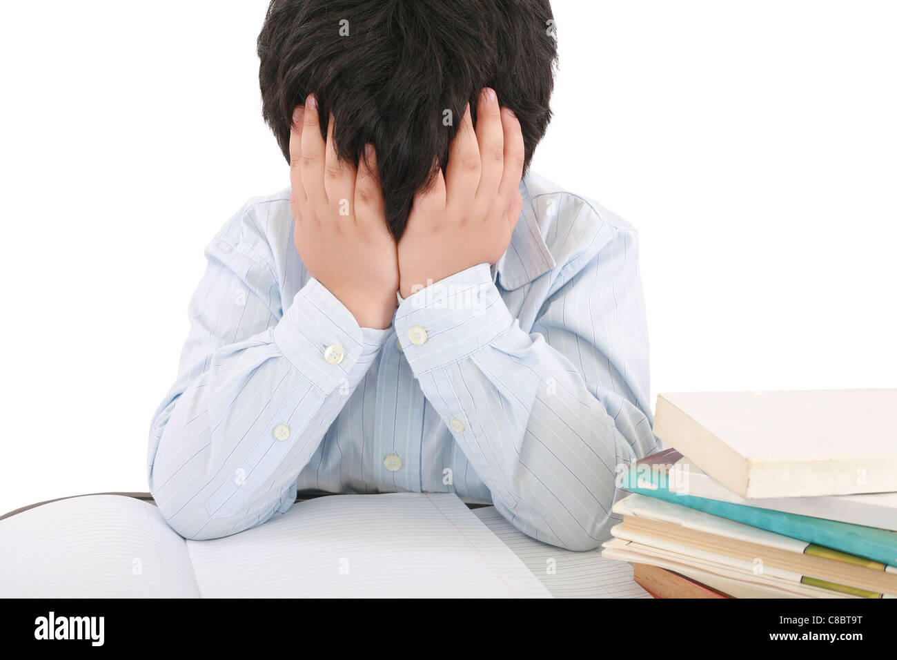 Schoolboy being stressed by his homework, isolated on white background ...
