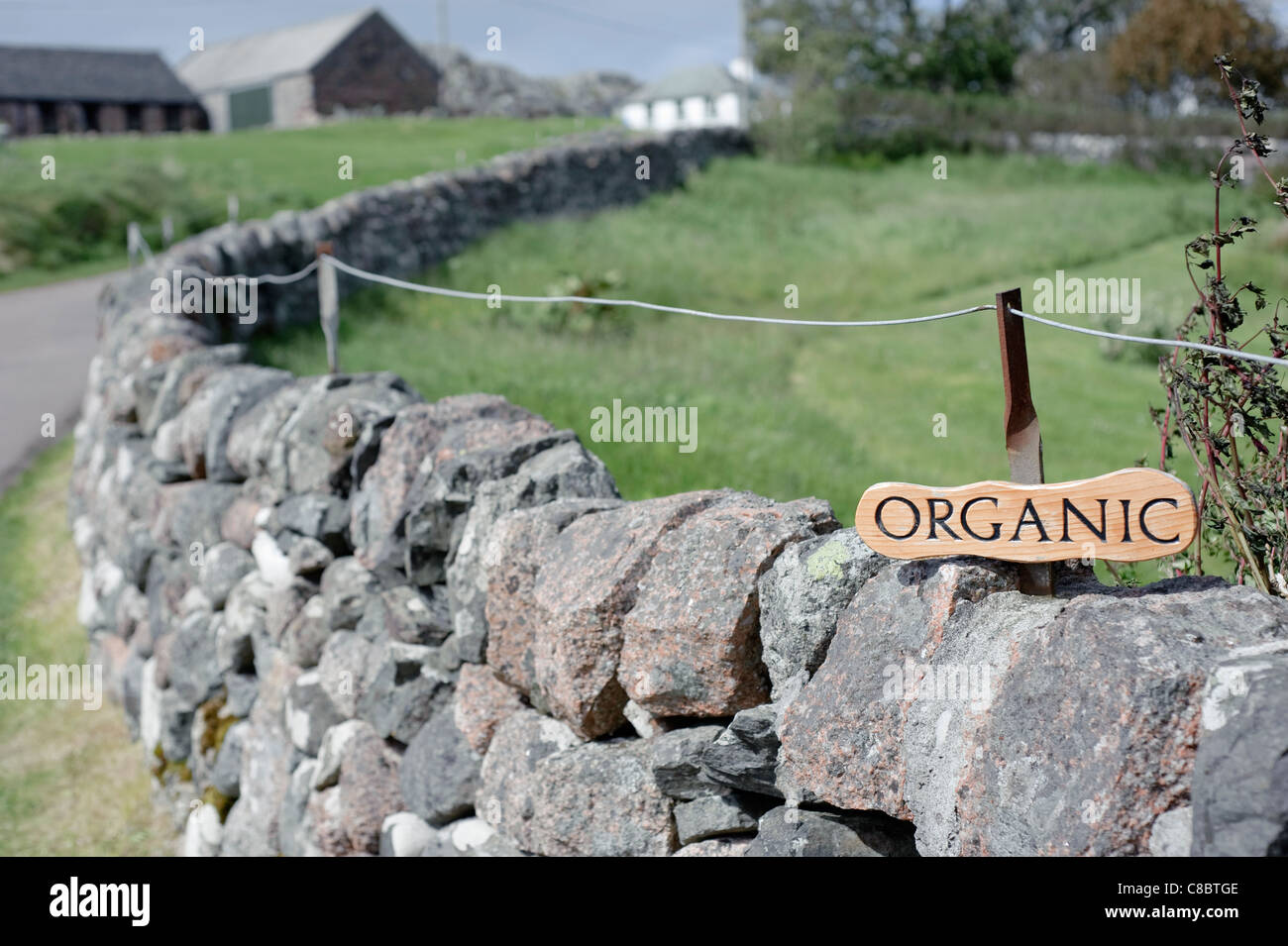 A sign on a dry stone wall denotes the fact that this is an organic ...