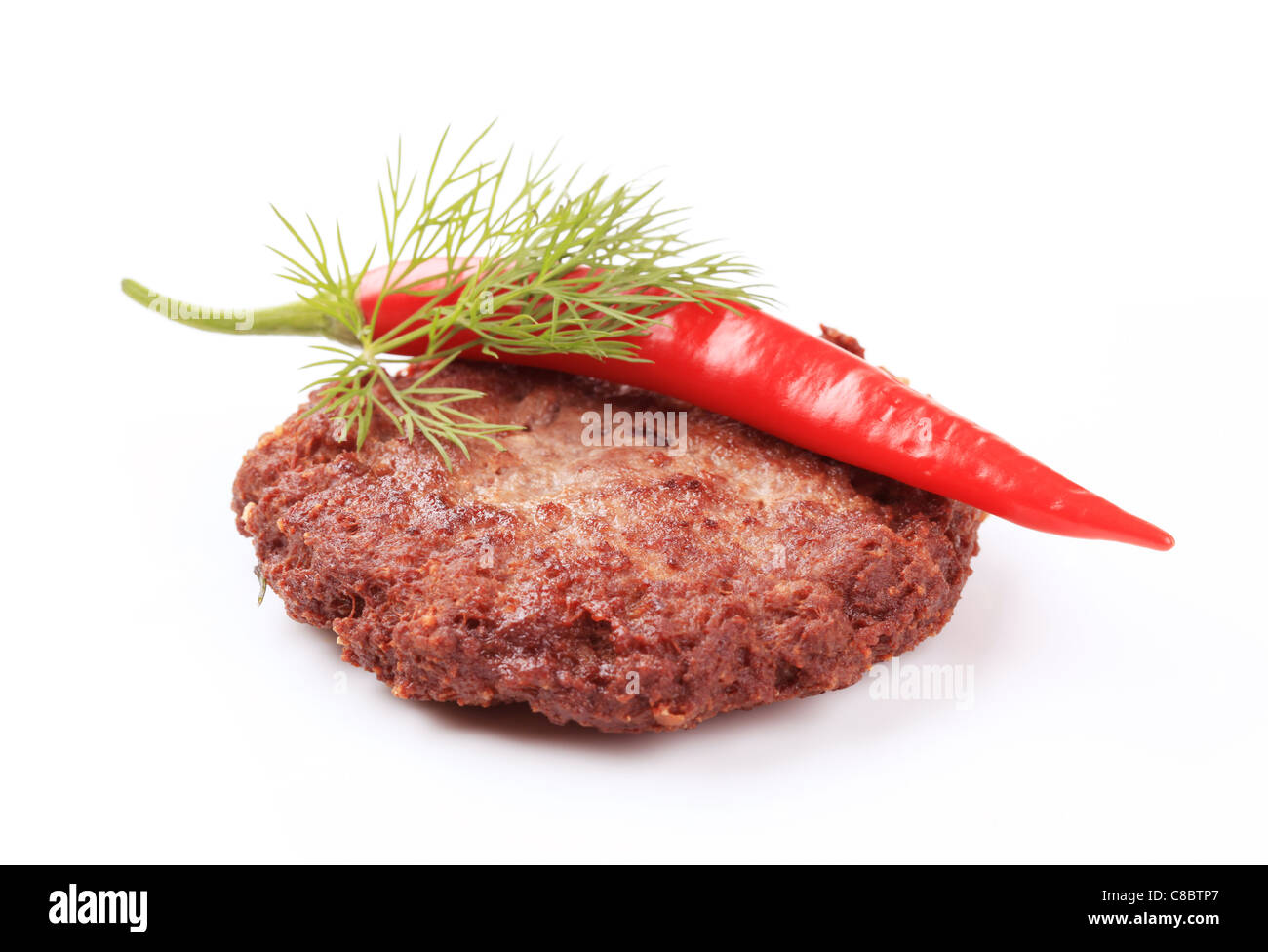 Pan fried hamburger patty and red chilli pepper Stock Photo - Alamy
