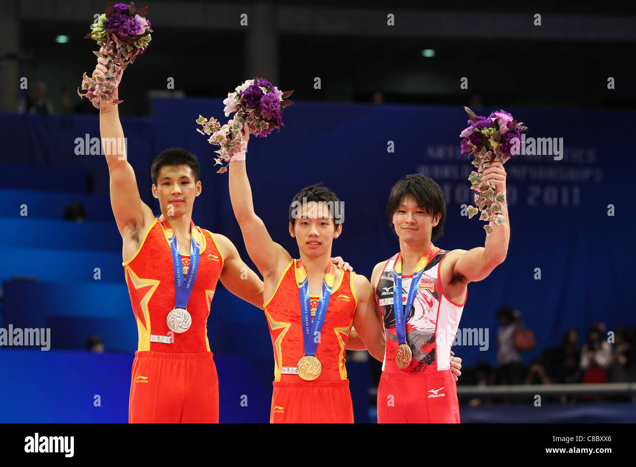 Zhang Chenglong (CHN), Zou Kai (CHN), Kohei Uchimura poses at the 2011 World Artistic Gymnastics ...