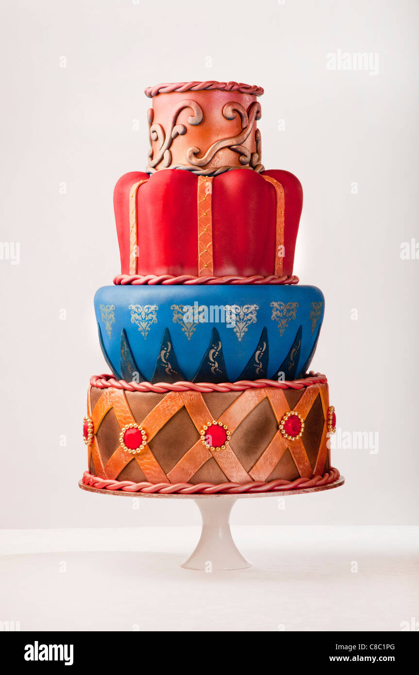 4 tiered aladden middle eastern red blue cake on stand on white ...