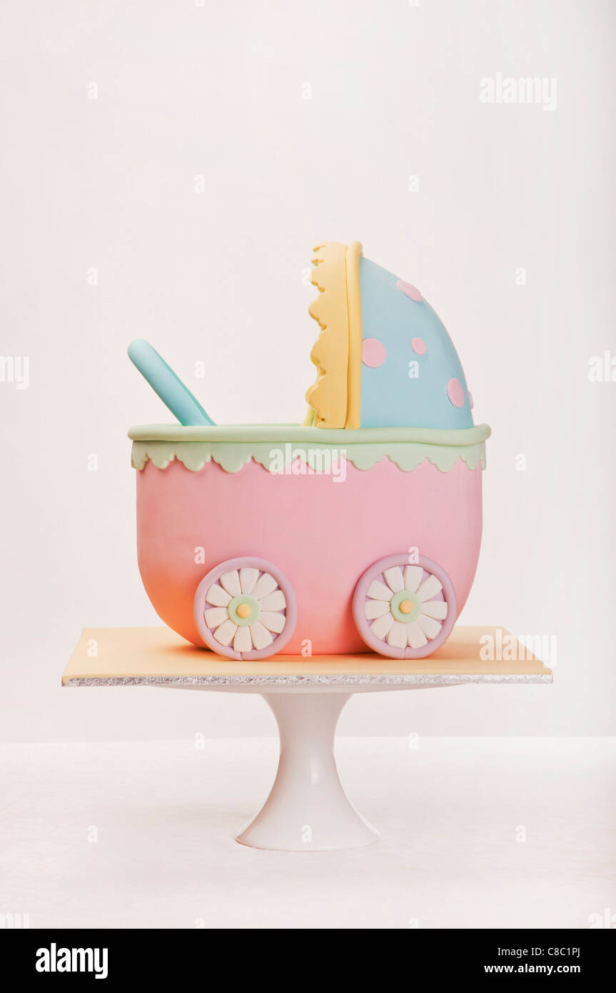 baby shower pram cake on stand on white background Stock Photo - Alamy