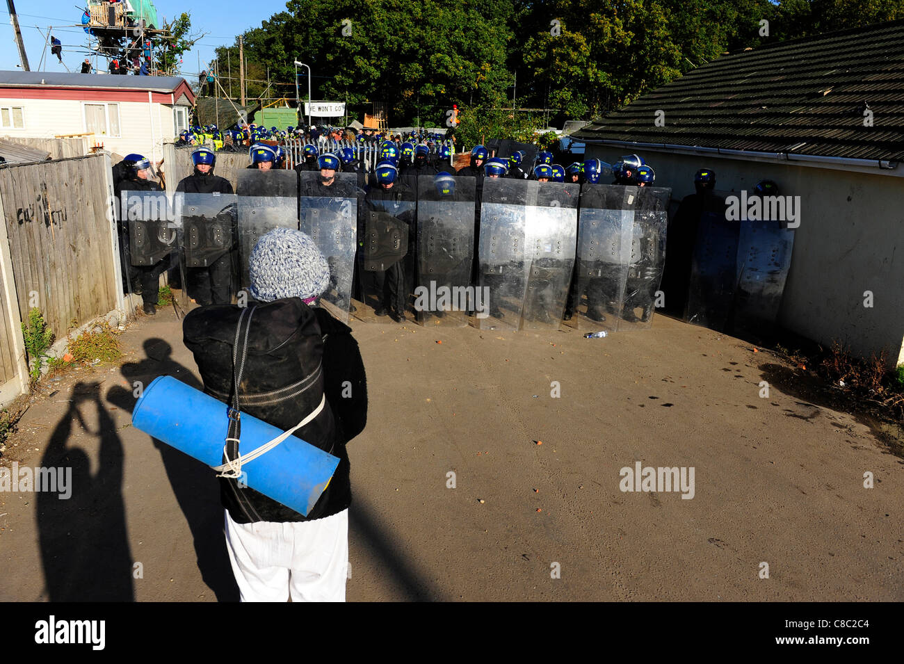 A line of police in riot gear form a barricade at Dale Farm travellers ...