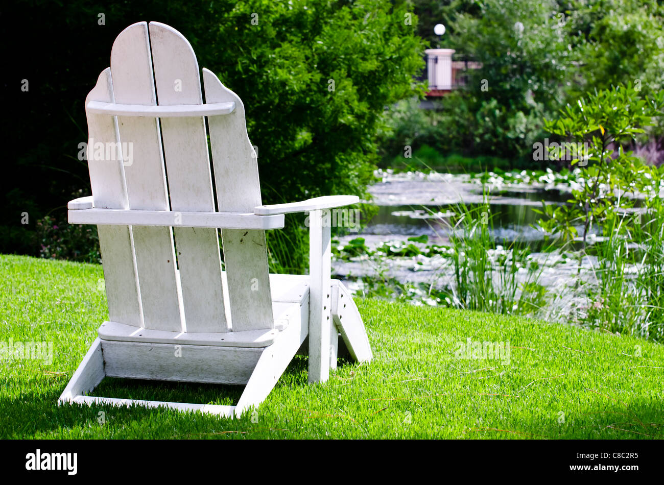 White Wooden Adirondack Chair - Overlooking Pond Stock Photo - Alamy